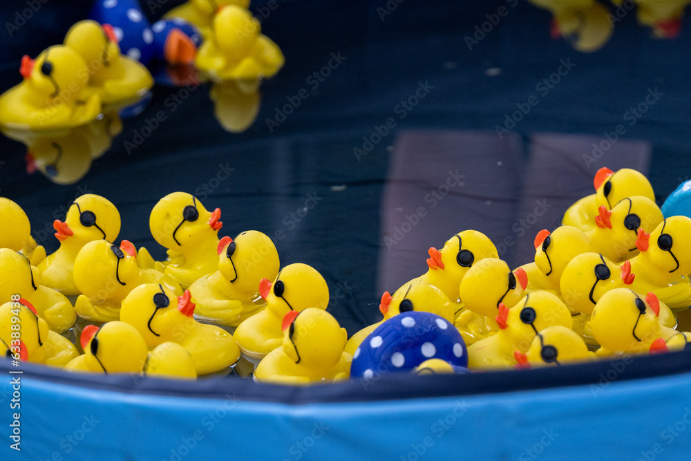 Small yellow plastic rubber duckies wearing black glasses with bright ...