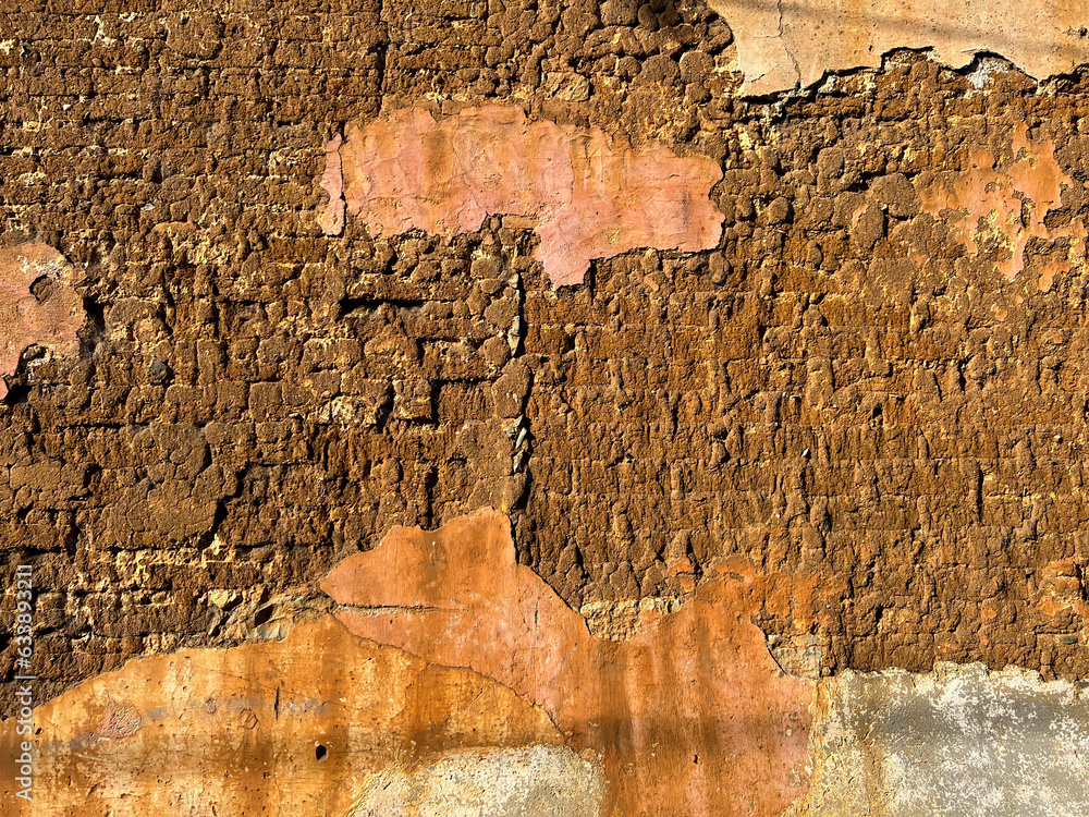 Grungy old deteriorating brick and adobe wall texture background in ...