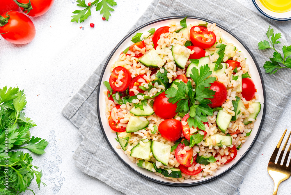 Bulgur tabbouleh salad with tomatoes, cucumbers and parsley ...