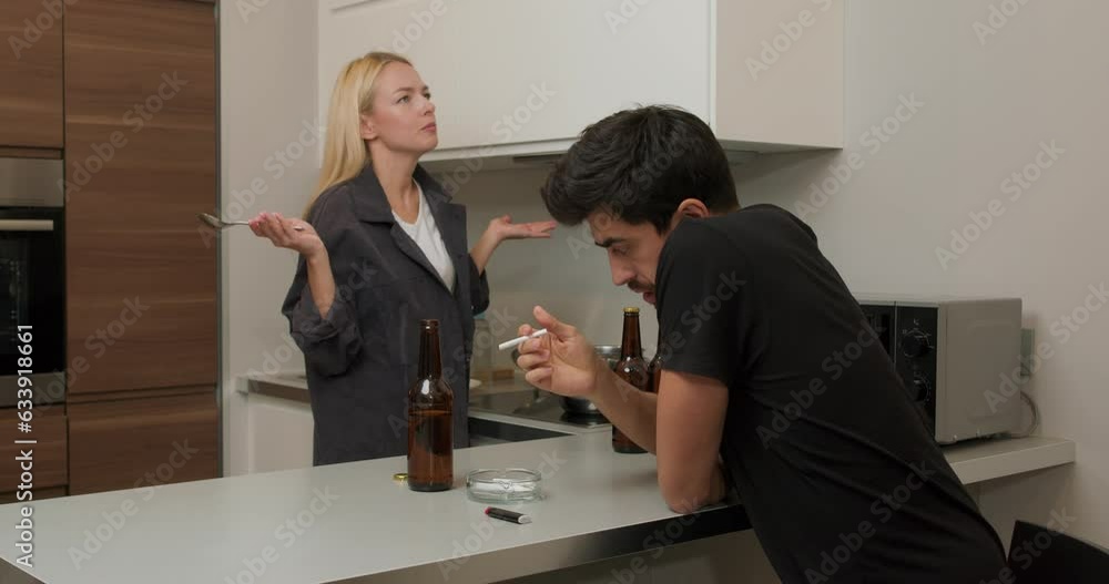 serious pensive drunk man holding cigarette sitting at table ignoring ...