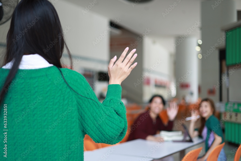 young girl student saying hello to her friend at university Stock Photo ...
