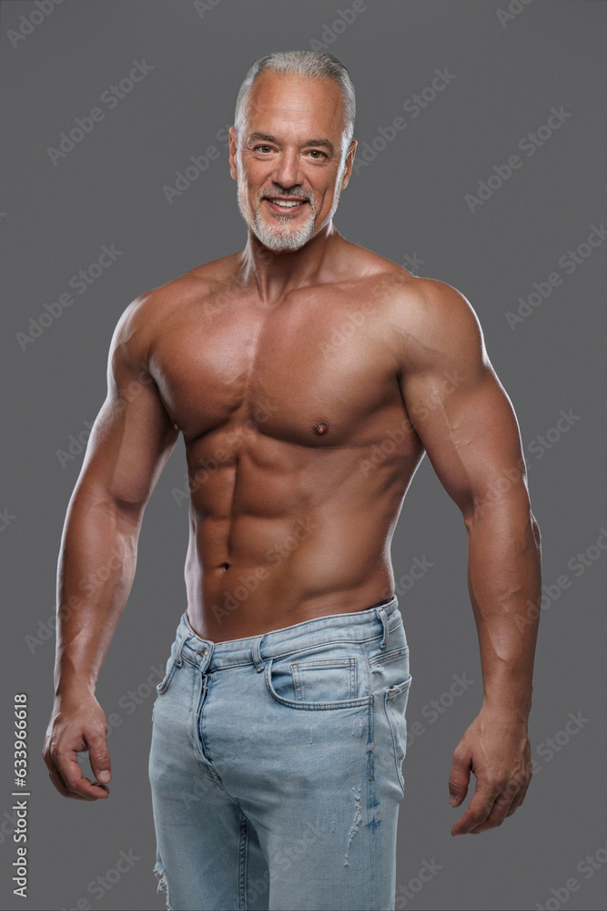 Attractive older man with a muscular physique, stylish gray beard and ...