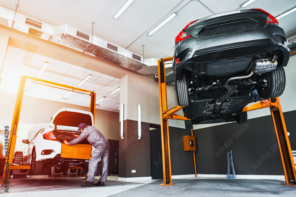 Precise Vehicle Care. Hydraulic Machine Lifting Modern Japanese Car for ...