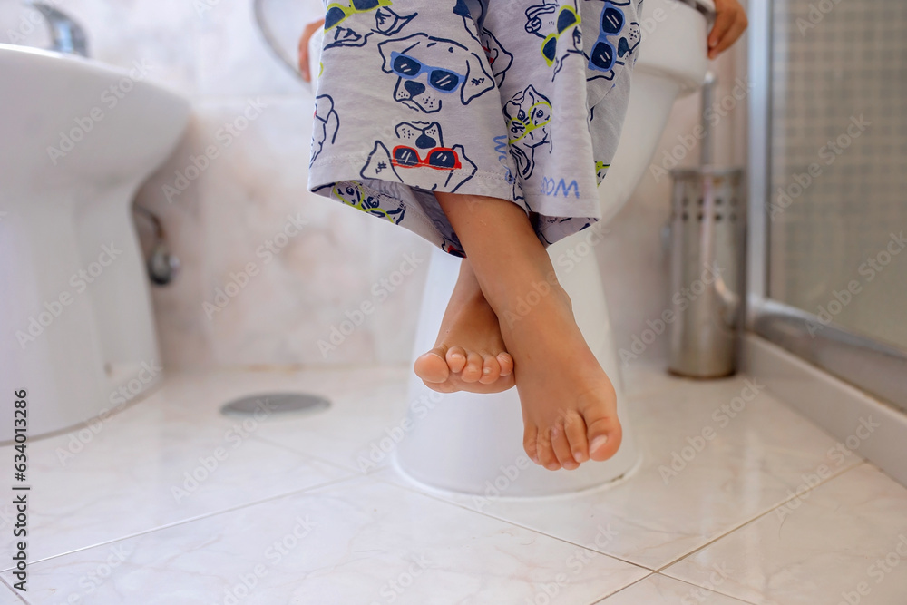 Cute child, boy, sitting on the toilet Stock Photo | Adobe Stock