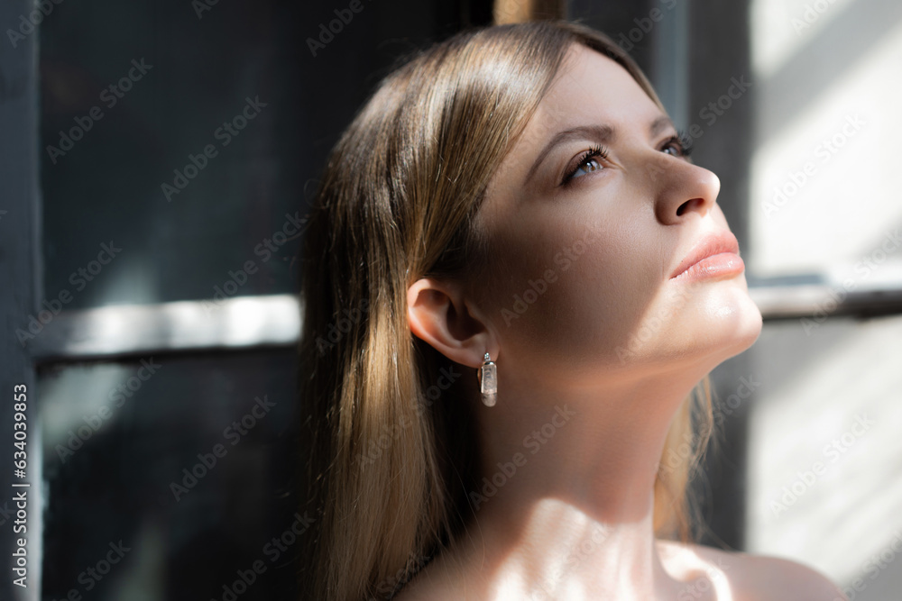 Beautiful young woman portrait in bright sunlight, contrast on the skin ...