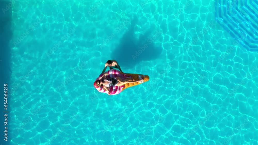 Sexy woman rest and sunbath on a float in the pool, top view aerial ...
