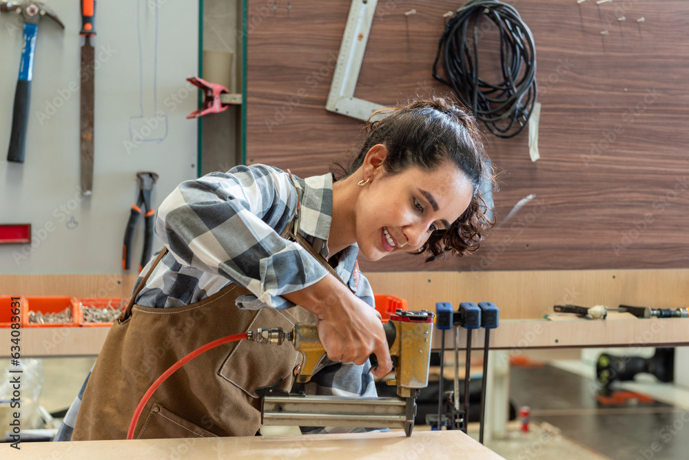One Strong confident young aged women carpenter standing aim at wood ...
