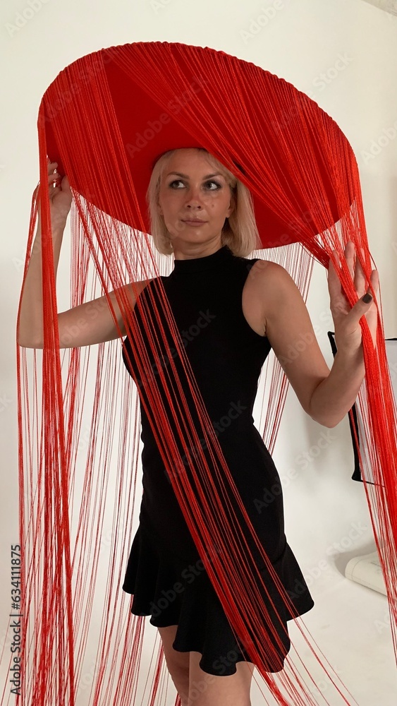 beautiful slim woman fashion model in a red hat in a photo studio ...