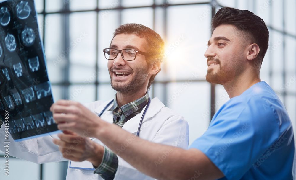 In a hospital sterile room, two professional radiographers hold and ...
