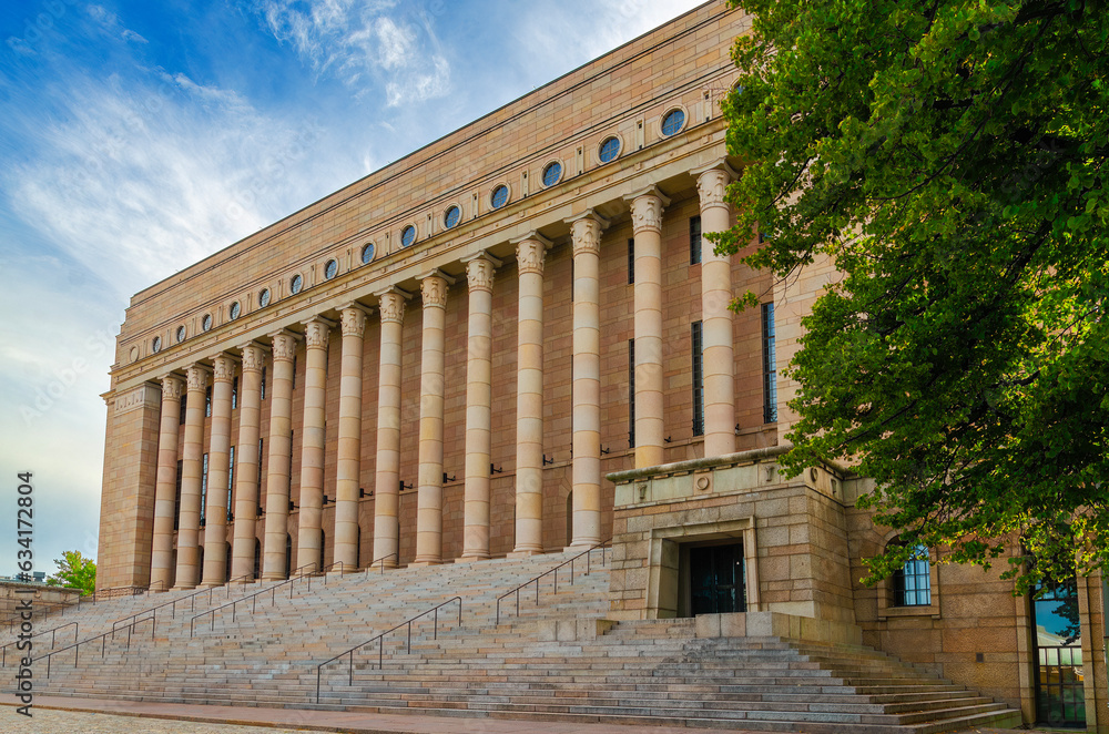 Parliament house of Finland in Helsinki. View from left behind the tree ...