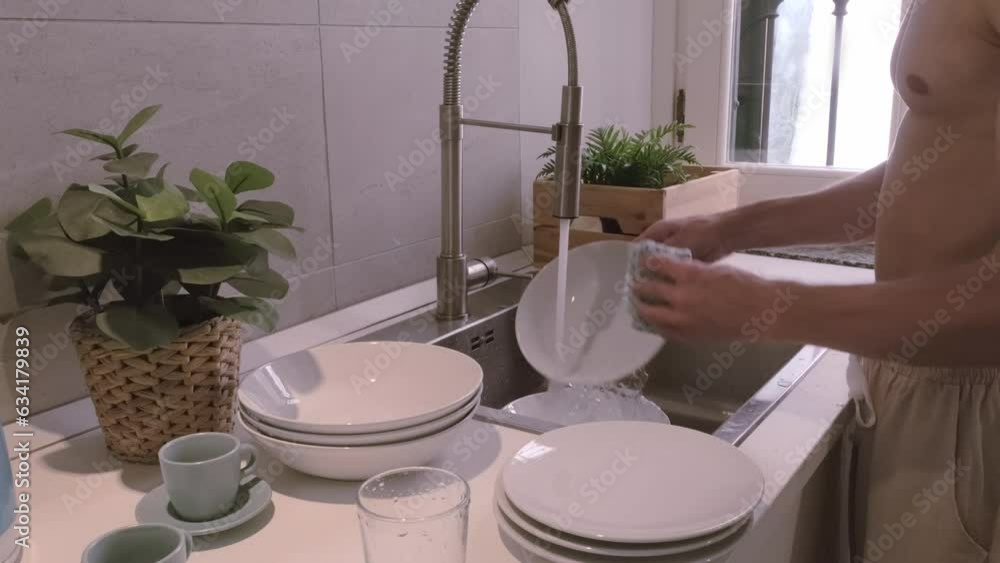 close-up male hands washing dishes, young man doing household chores in ...