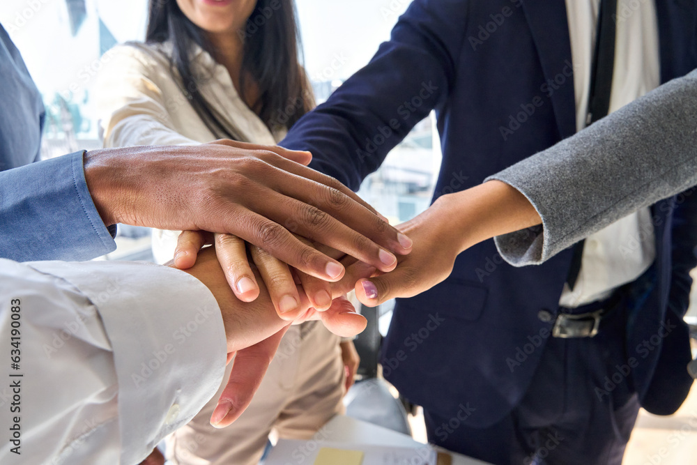 Diverse business team people joining hands together in stack expressing ...