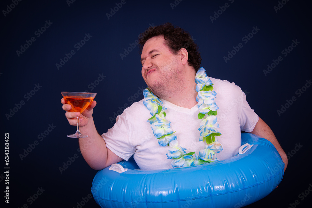 Funny fat man on vacation. A guy with an inflatable ring poses in the ...