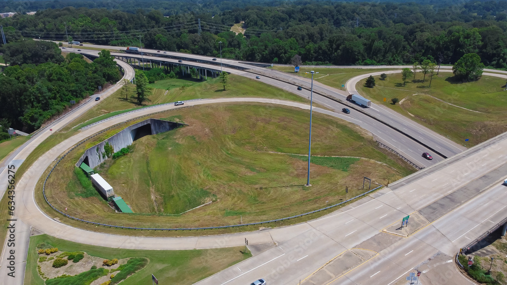 Circular highway exit or ring road with railroad tunnel, large drainage ...