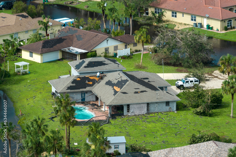 Destroyed by hurricane strong wind private house with damaged rooftop ...