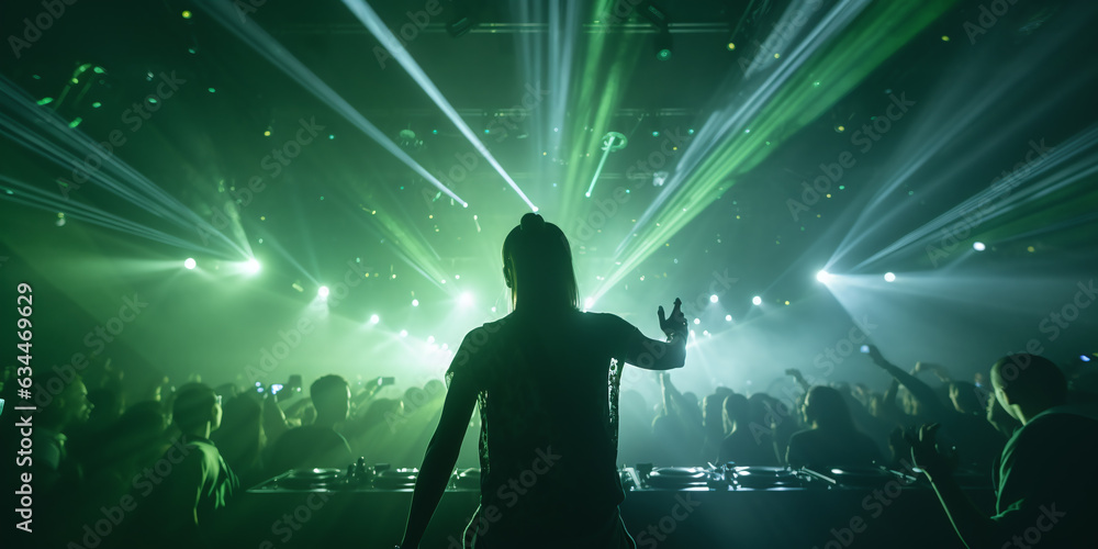 Techno rave party club. DJ booth in front of dancing party people ...