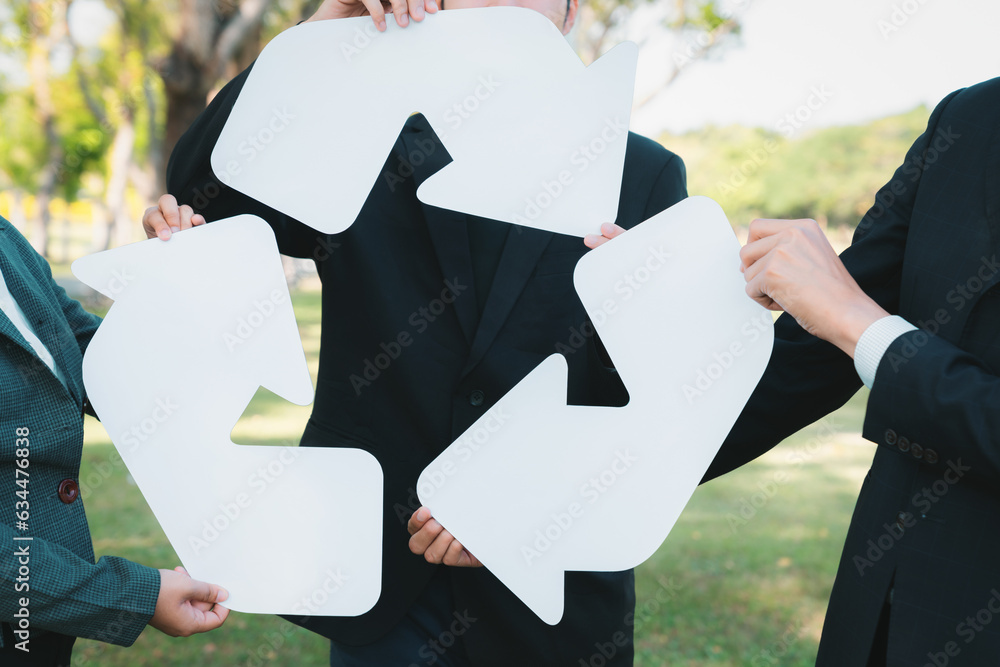 Business people holding pieces of reverse arrow icon into recycle ...