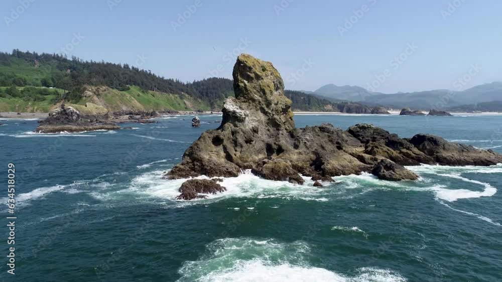 An orbiting drone shot, rotating around an isolated sea mount, off the ...