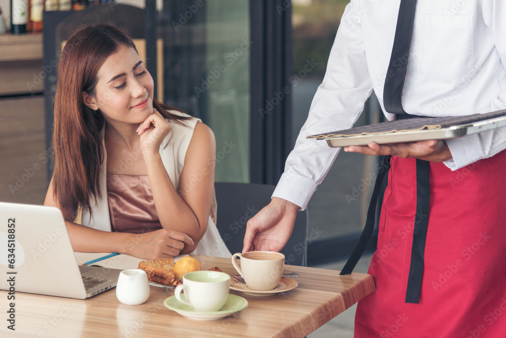 Restaurant business Handsome waiter serving food to young beautiful ...