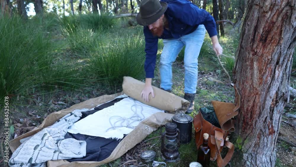 An Australian bush man rolls out his historic swag in the Australian ...