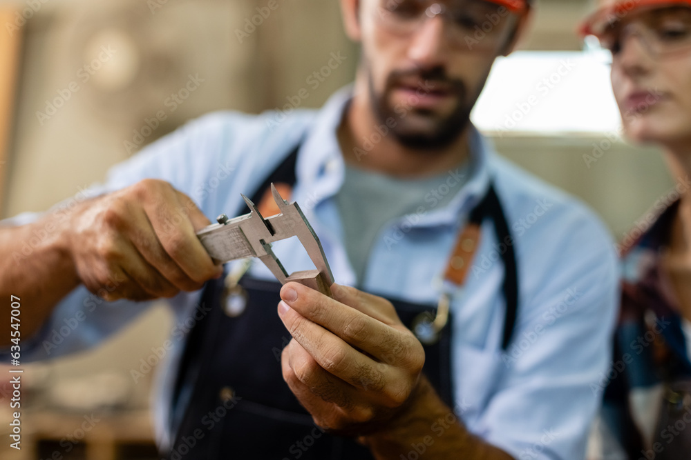 Foto de Worker carpenter or craftsman using vernier calipers measuring ...