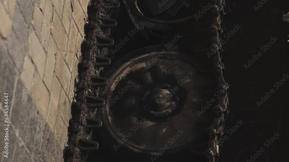 Caterpillars of a burned-out Russian army tank in Ukraine. Side view of ...