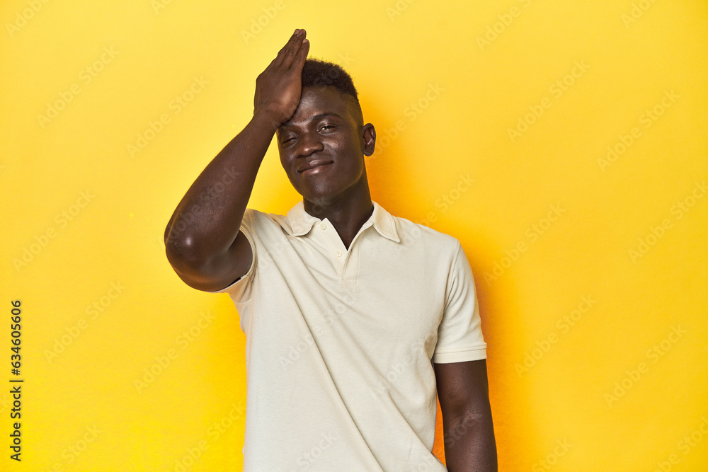 Stylish young African man on vibrant yellow studio background ...