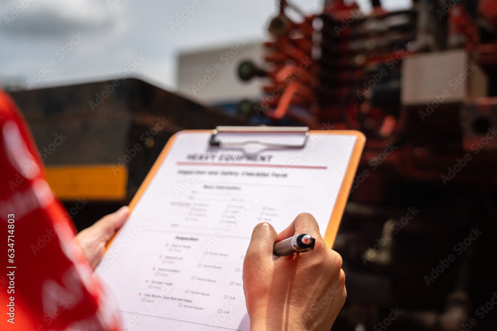 A mechanical engineer is inspecting the condition of truck crane ...