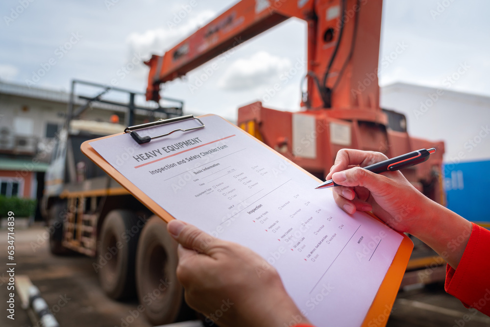 A mechanical engineer is inspecting the condition of truck crane ...