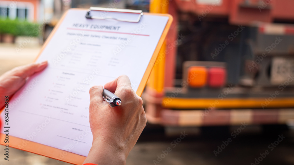 A mechanical engineer is inspecting the condition of truck crane ...