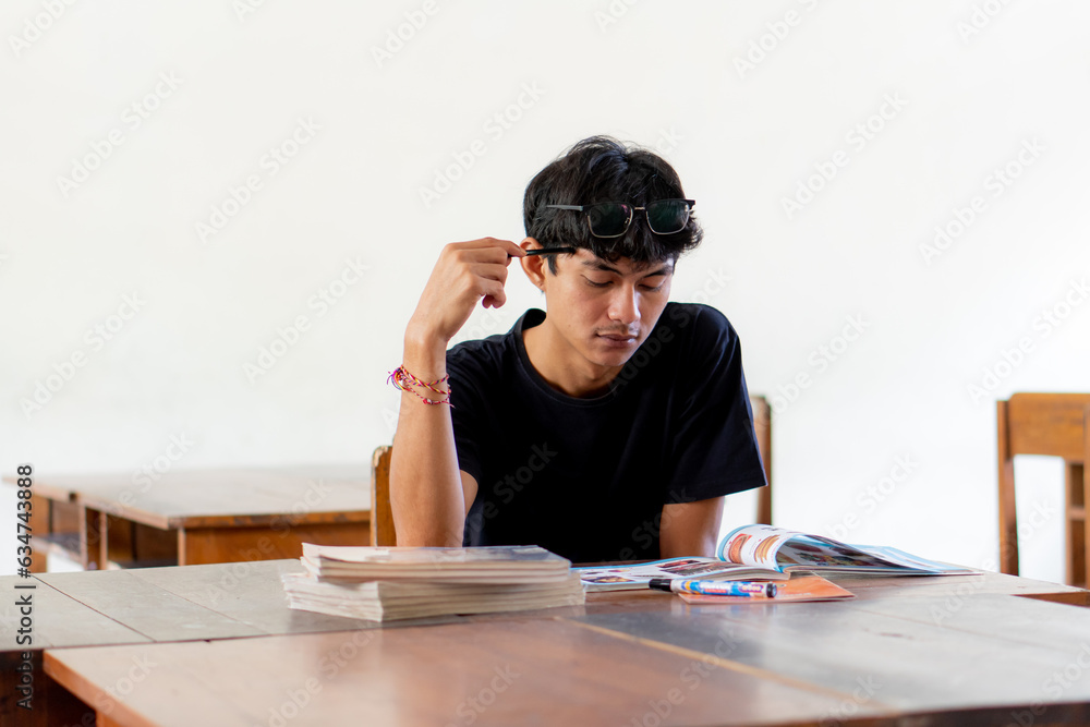 Overworked and tired high school student man studying feeling depressed ...