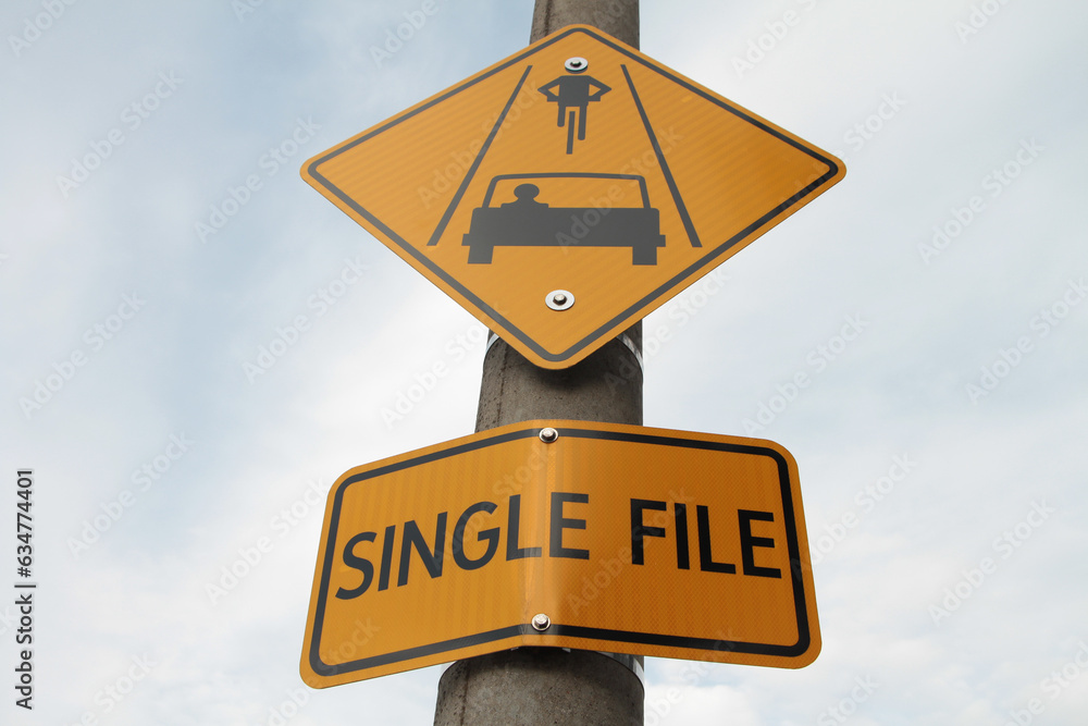 yellow single file caption rectangle sign with yellow diamond sign ...