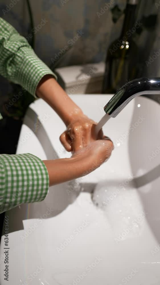 Filmed from a top-down perspective, the shot displays female hands ...