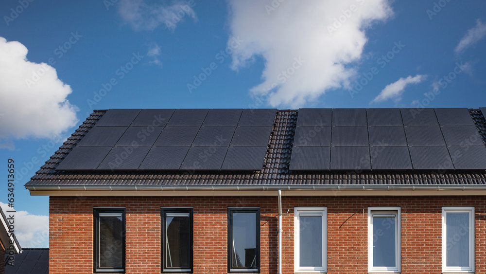 Newly build houses with solar panels attached on the roof Close up of ...