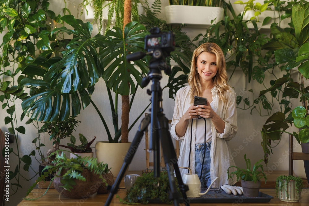 Plant-loving blogger in a white shirt and jeans, smiling in the natural ...