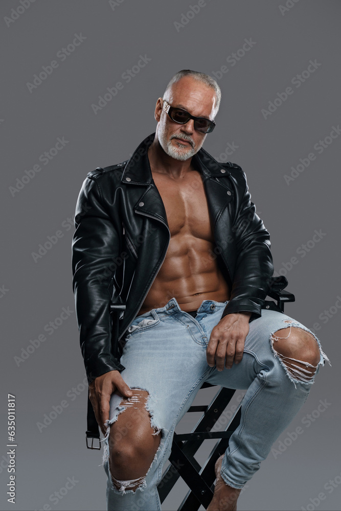 Handsome toned male model with a stylish gray beard with sunglasses ...