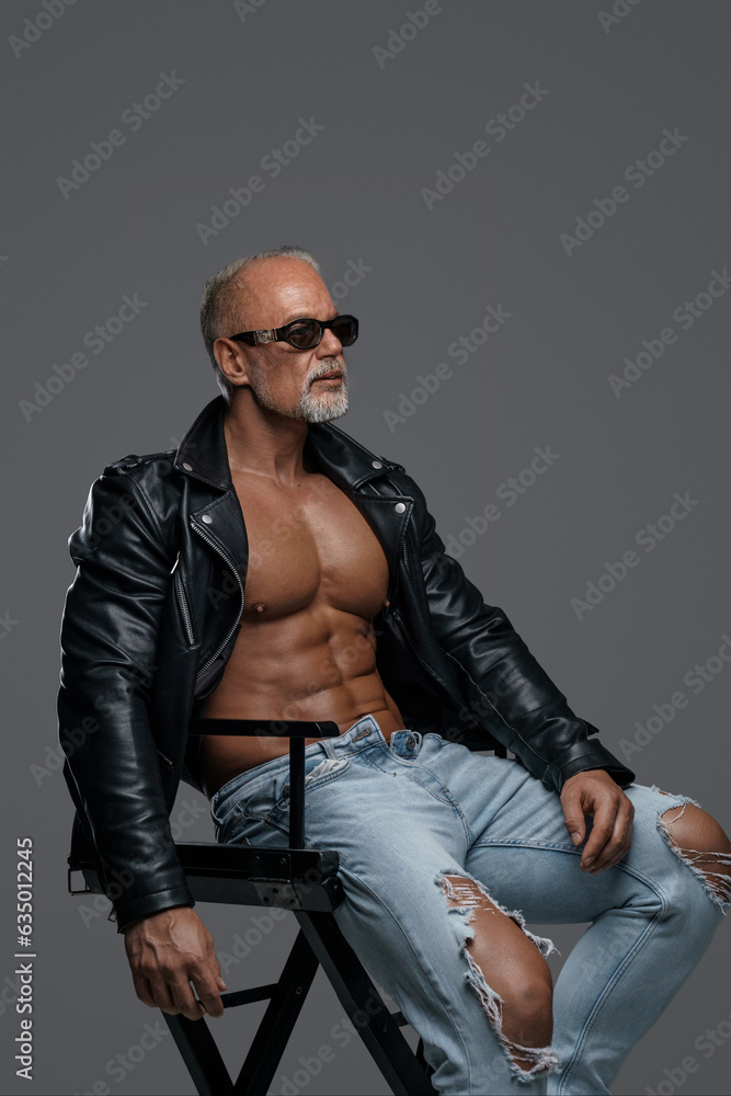 Charismatic muscular male model of mature age with a stylish gray beard ...