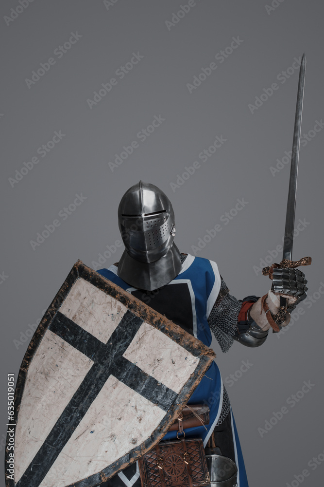 Medieval knight in active battle pose, wielding sword and shield ...