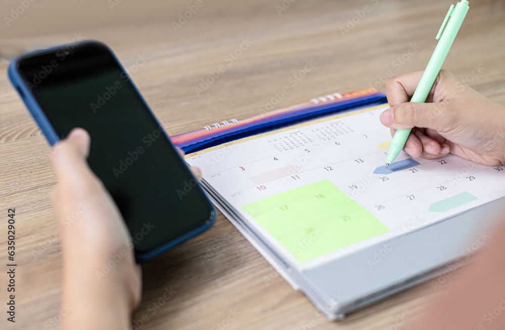 Woman holding mobile phone for checking appointments on mobile phone ...