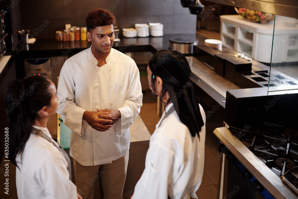 Chef discussing new menu with his team in the beginning of shift Stock ...
