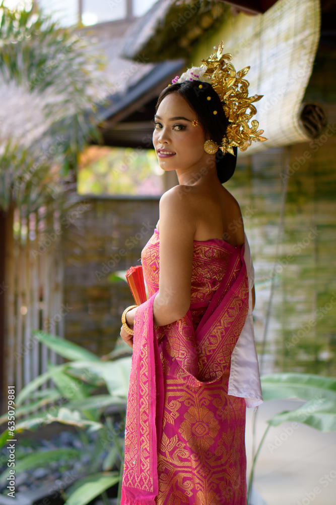 Beautiful female model in a pink-white traditional suit with a ...