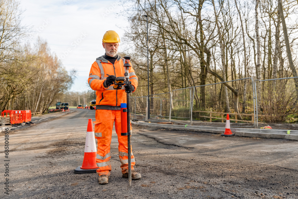 Site engineer operating his touch screen controller instrument during ...