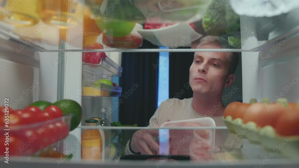 Man Opening Fridge Door with Healthy Food and Taking Products. Hungry ...