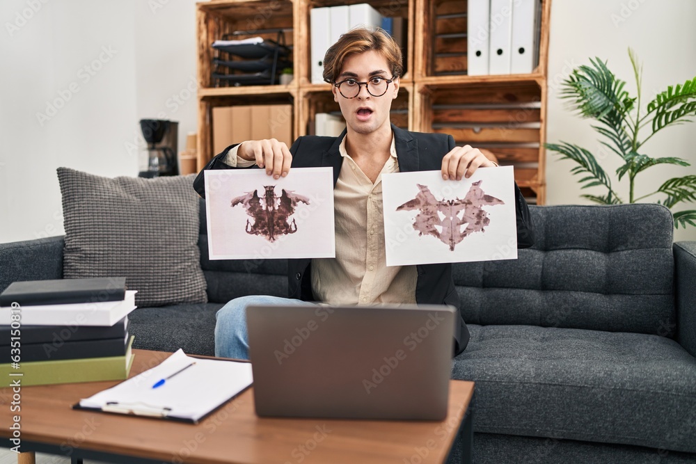 Young therapist man working with rorschach test at psychology clinic ...