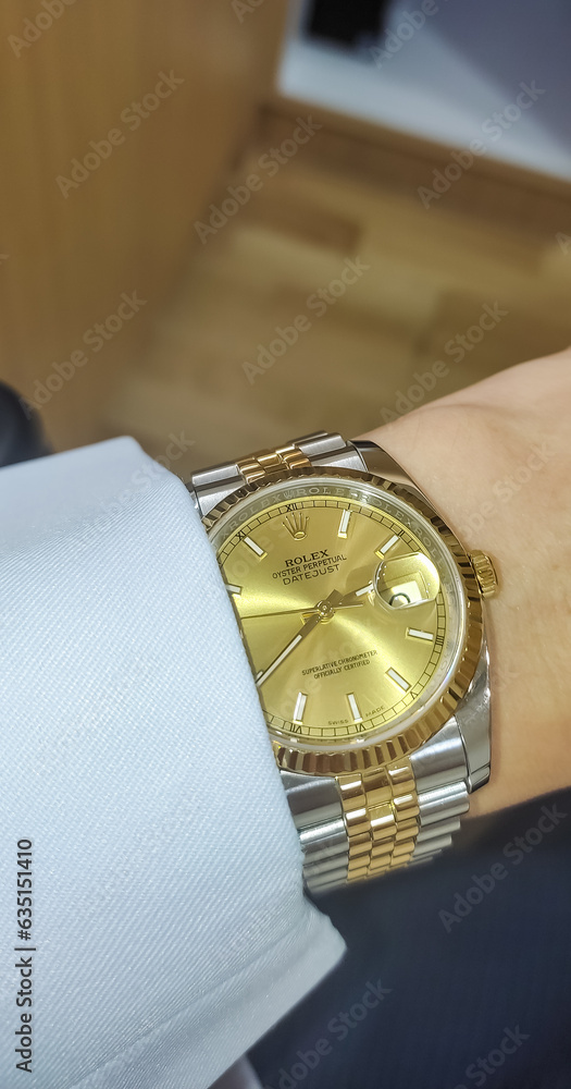 BANGKOK - AUGUST 12 : Rolex Datejust model, yellow gold fluted bezel and dial with two tone ...