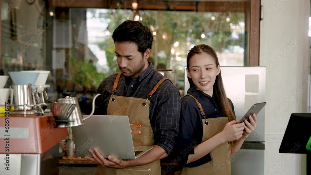Asian couple runs cafe bakery together, man holding laptop computer ...
