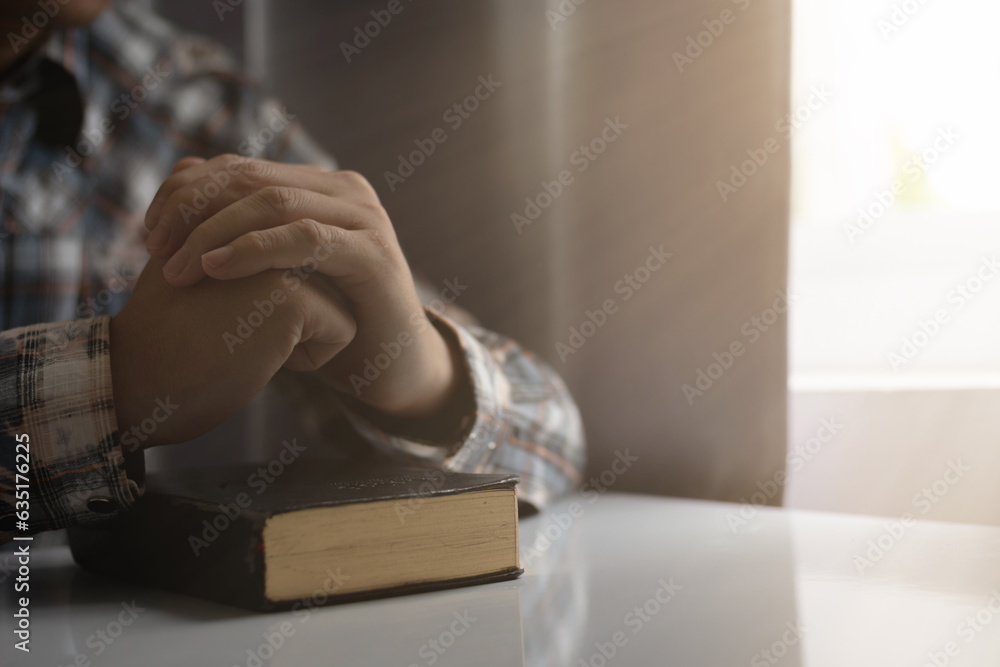 young man was praying to God in front of Bible with faith and power of ...