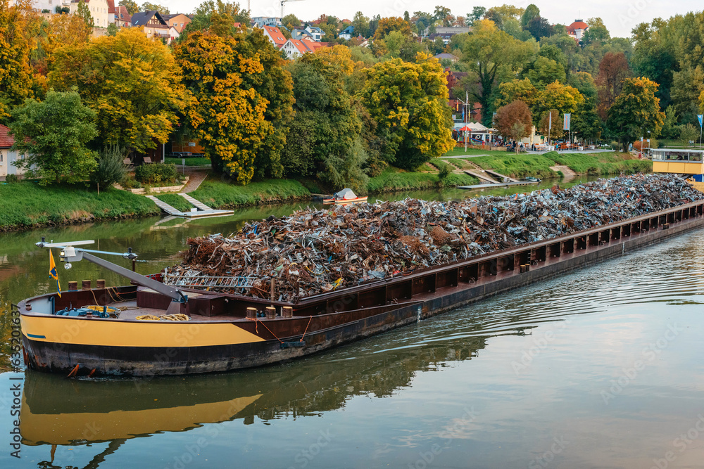 Transportation industry. Ship barge transports scrap metal and sand ...