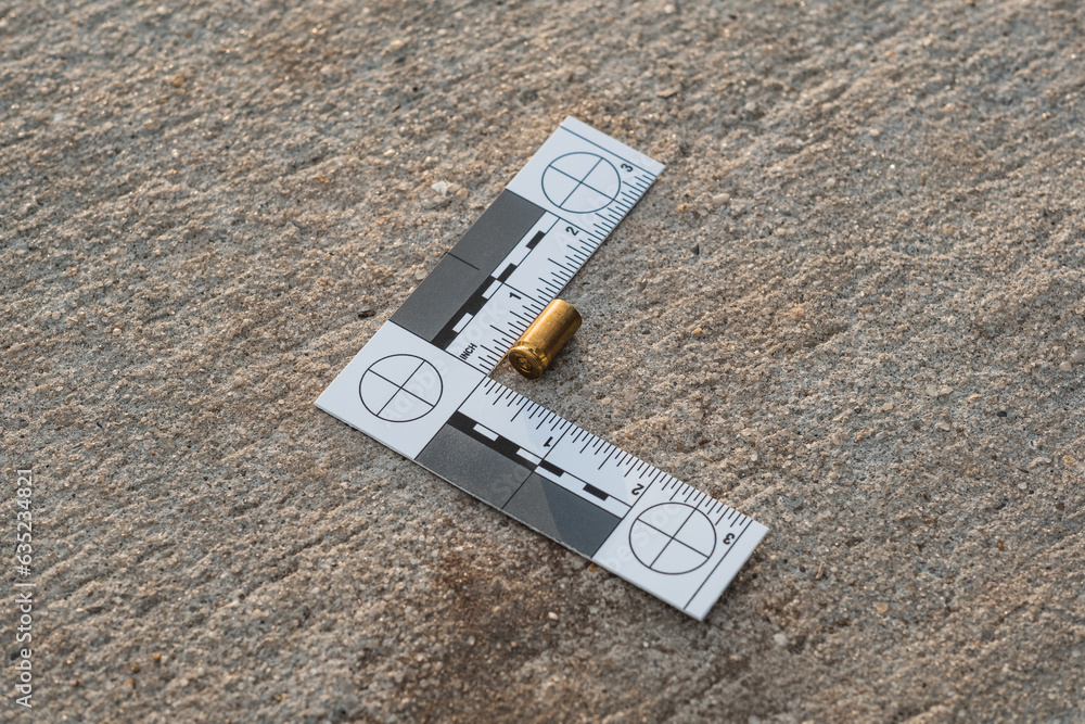 One crime scene evidence ruler on the street after a gun shooting brass ...