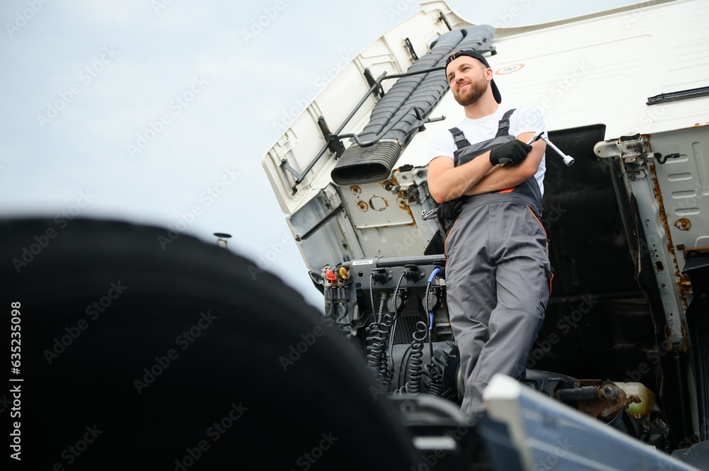 Semi Truck Under Maintenance. Caucasian Truck Mechanic Working to Fix ...